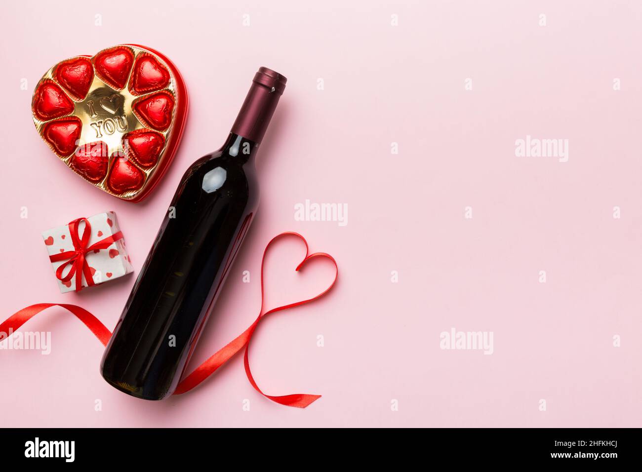 Bottle of red wine on colored background for Valentine Day with gift ...