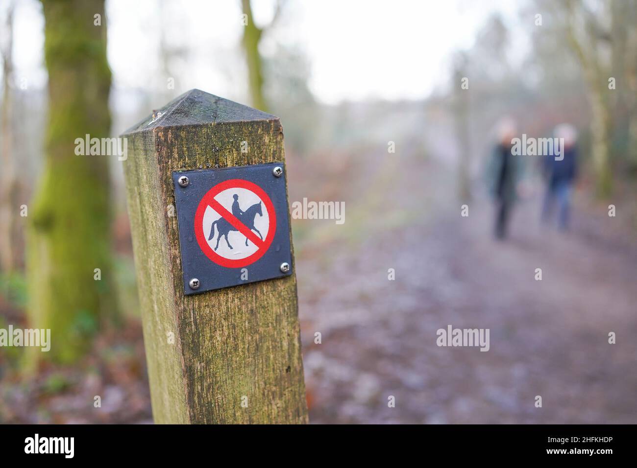 No bridleway sign on a post with walkers in the background Stock Photo ...