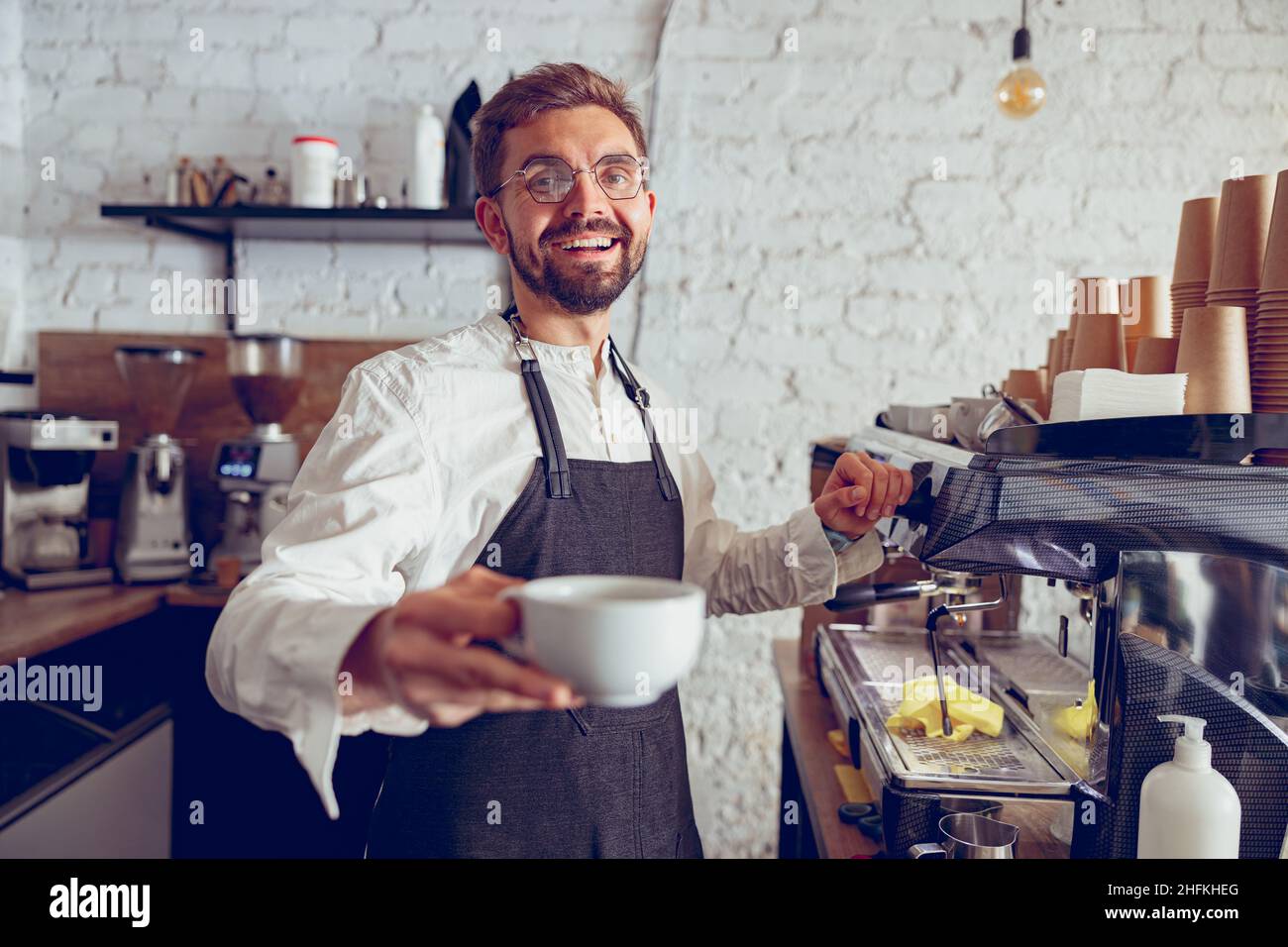 Man offering coffee cup hi-res stock photography and images - Alamy