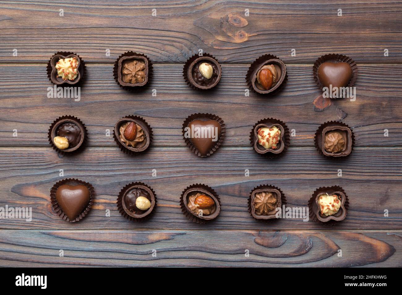Different kinds of chocolates on colored table close-up. Top View and ...