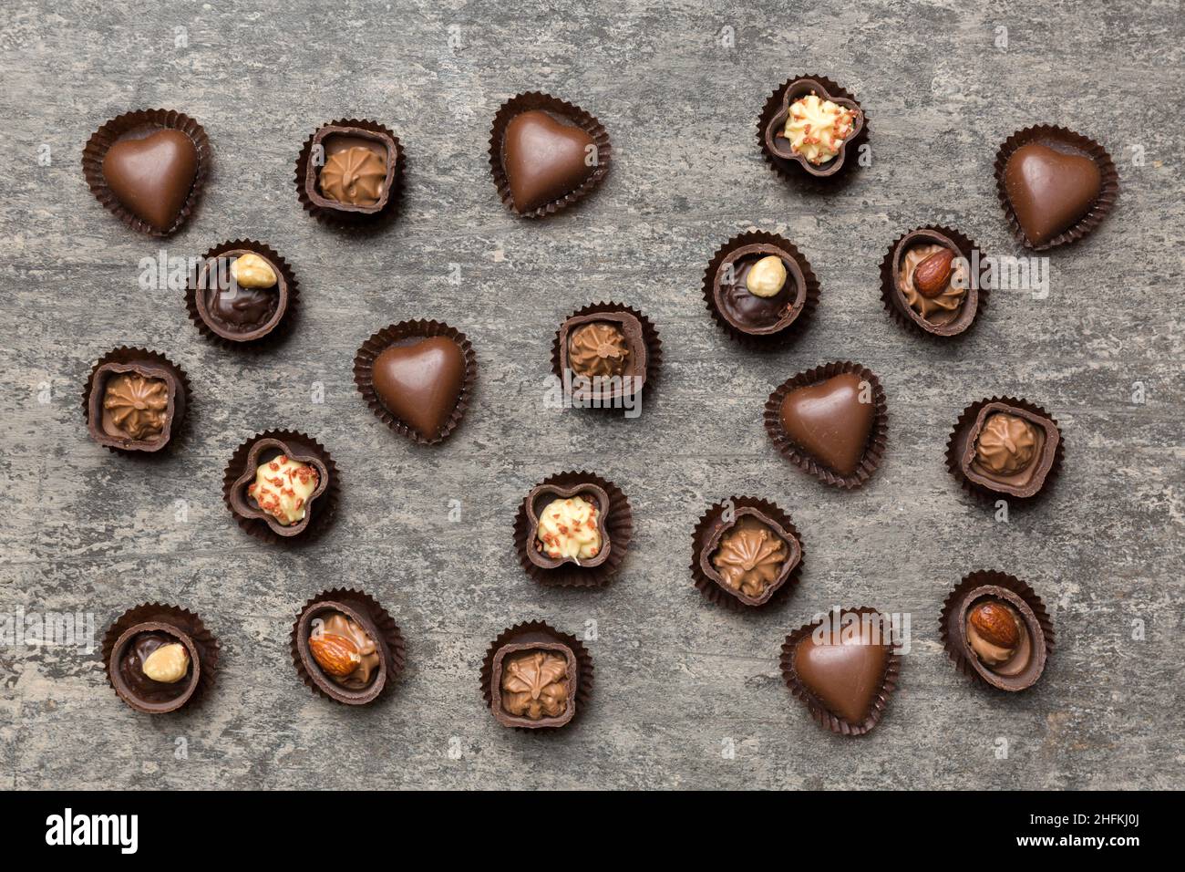 Different kinds of chocolates on colored table close-up. Top View and ...