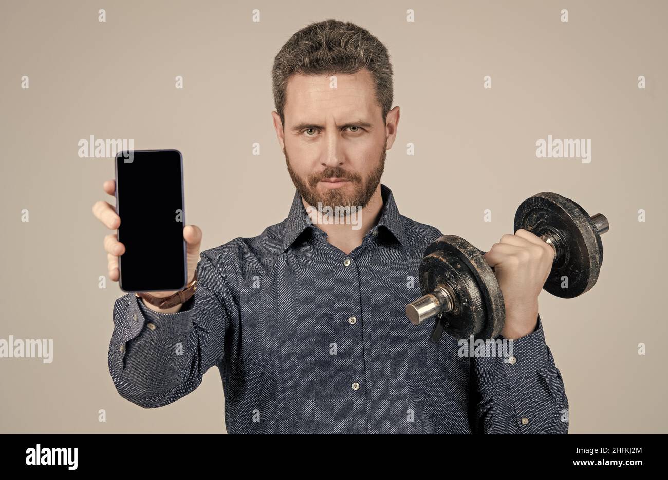 strong bearded man businessman training with barbell and presenting ...