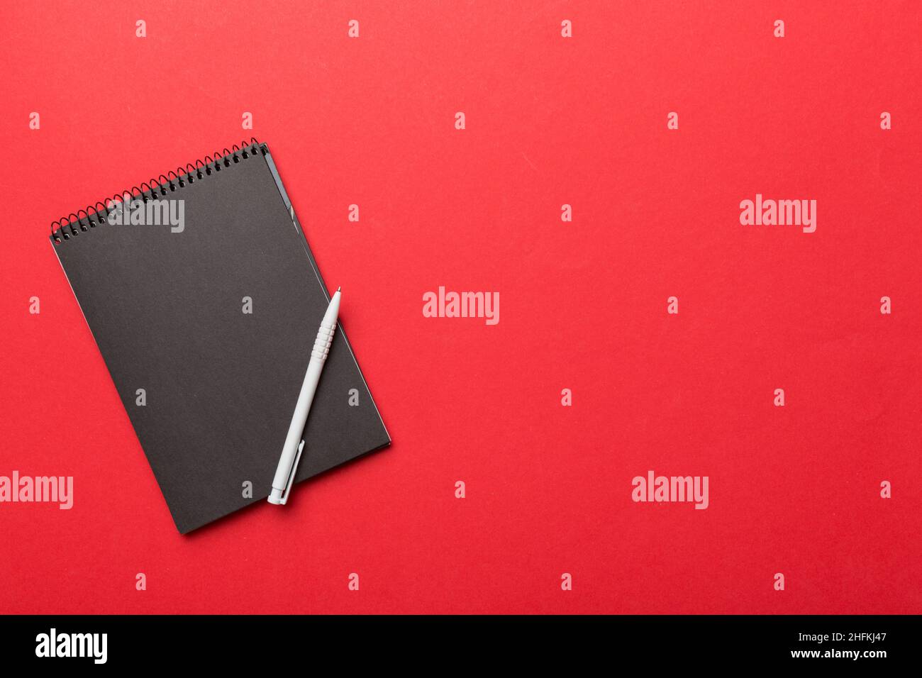 school notebook on a colored background, spiral black notepad on a ...