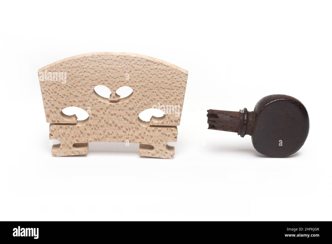 Close up of wooden string bridge for resting strings of violin or viola ...