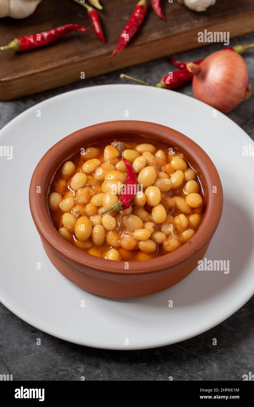 Hot turkish bean stew on dark background. Ispir beans cooked in a ...