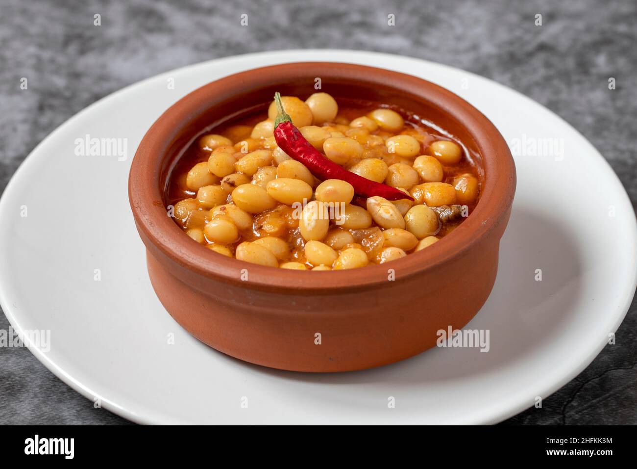Hot turkish bean stew on dark background. Ispir beans cooked in a ...
