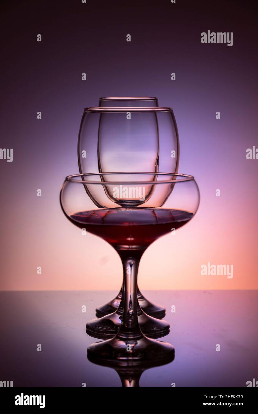 Glassware of different sizes against colorful background Stock Photo ...