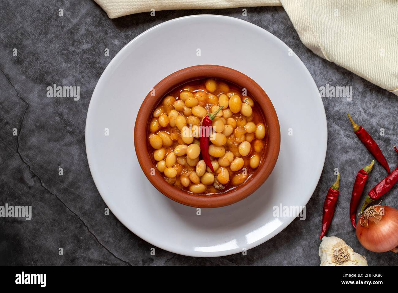 Hot turkish bean stew on dark background. Ispir beans cooked in a ...
