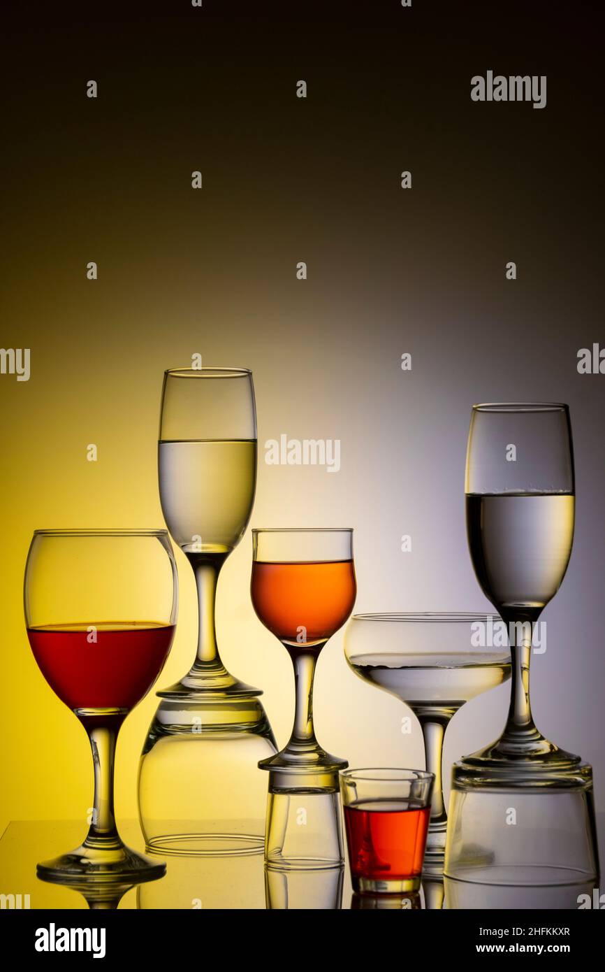 Glassware of different sizes against colorful background Stock Photo ...