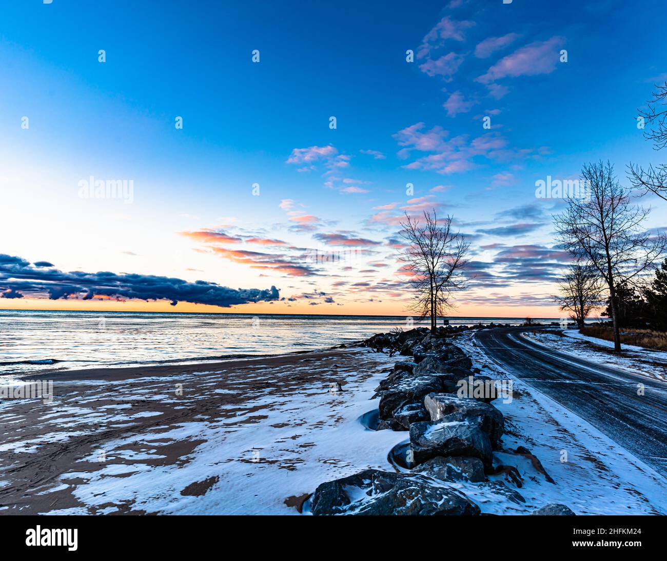 Tawas Point cold Ice Road Sunrise with iced over Road Stock Photo - Alamy
