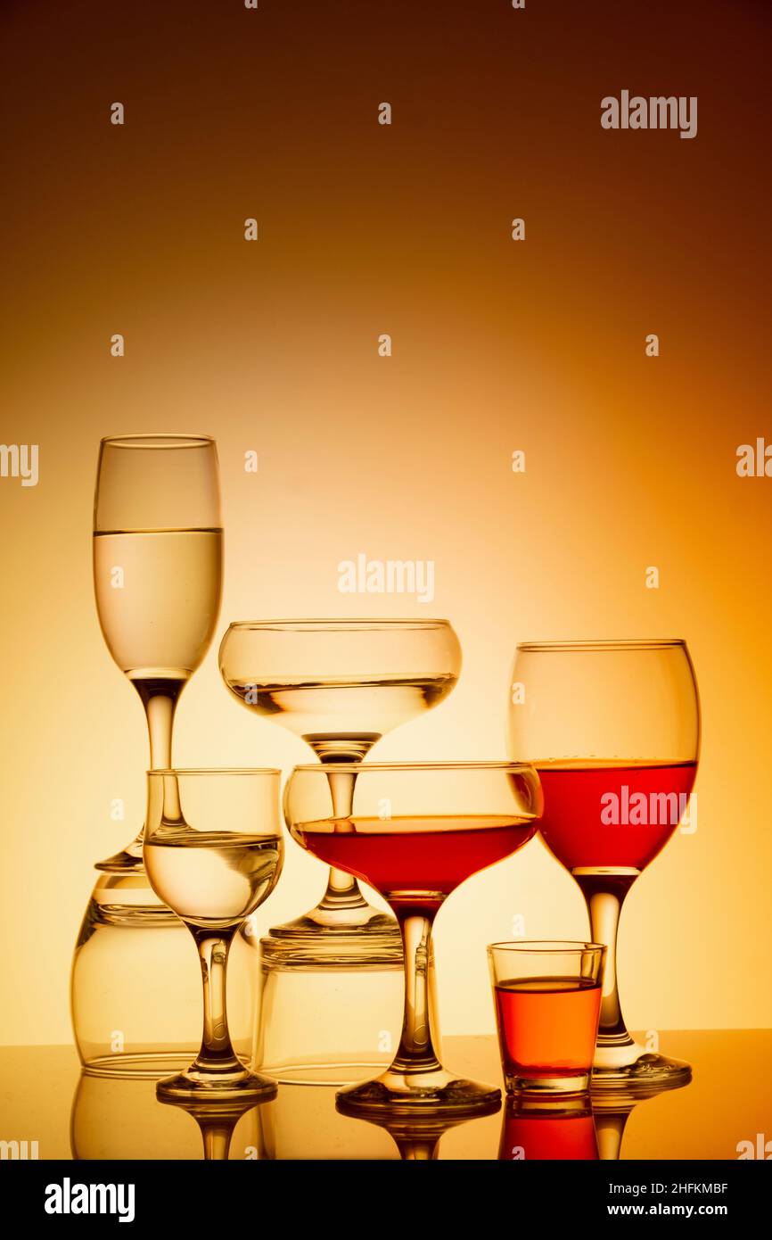 Glassware of different sizes against colorful background Stock Photo ...