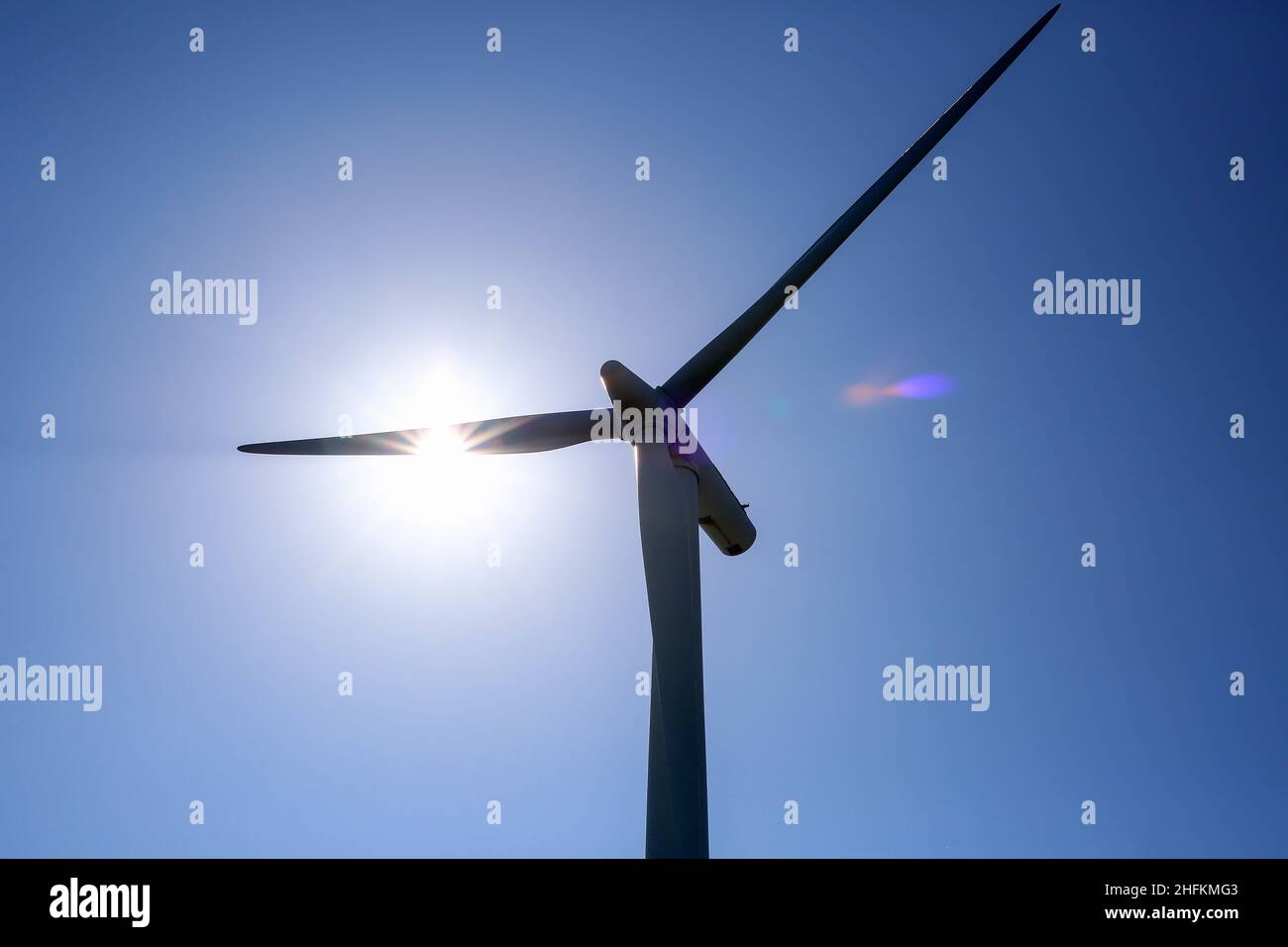 Wind generator closeup on the blue background with sun light Stock ...