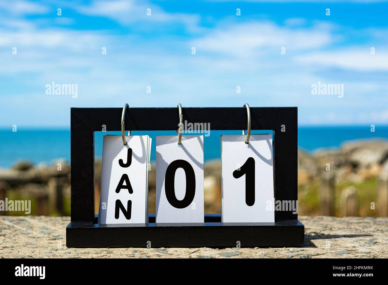 Jan 01 calendar date text on wooden frame with blurred background of ...