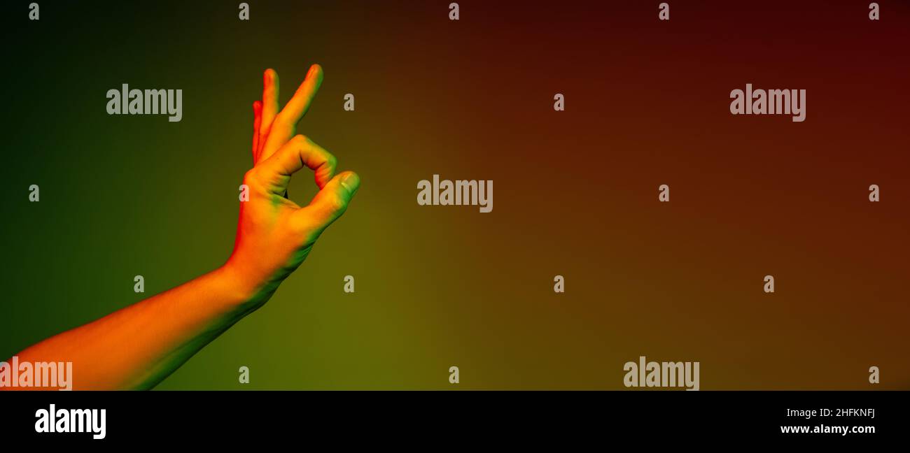 Studio shot of aethentic human hand gesturing isolated on dark studio ...