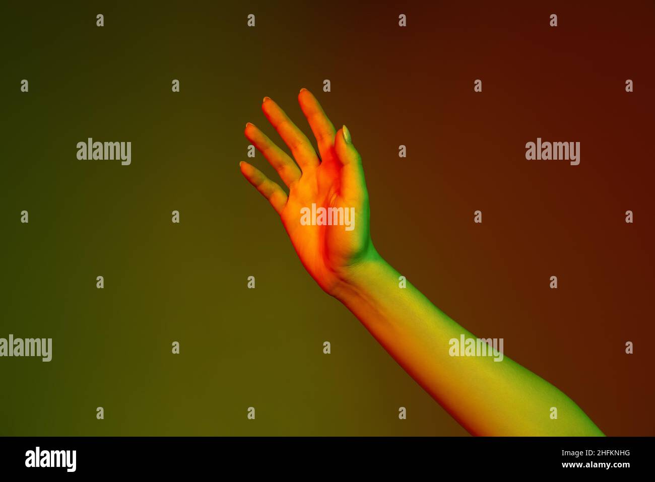 Studio shot of aethentic human hand, open palm isolated on dark studio ...