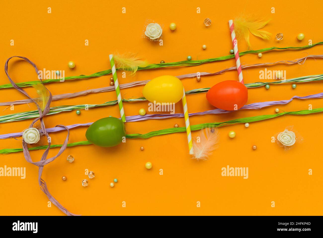 Musical notes make from Easter eggs on yellow background. Easter ...