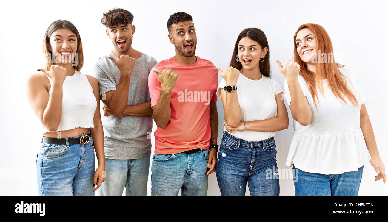 Group of young friends standing together over isolated background ...
