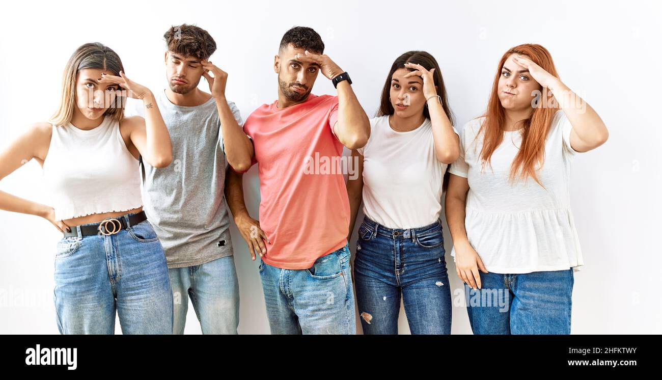 Group of young friends standing together over isolated background ...
