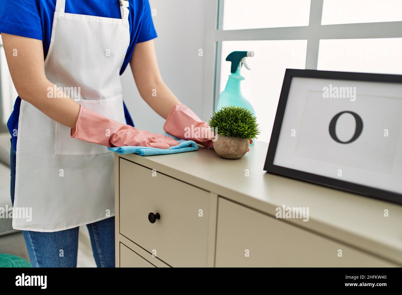Woman cleaning table using rag and diffuser at home Stock Photo - Alamy