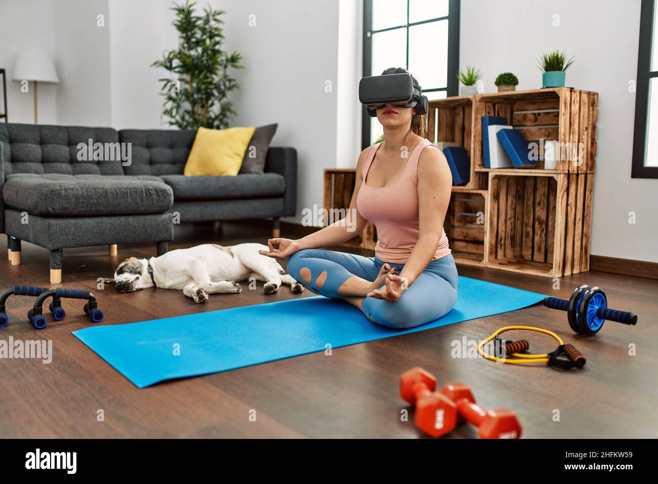 Young woman having online yoga class using vr goggles at home Stock ...