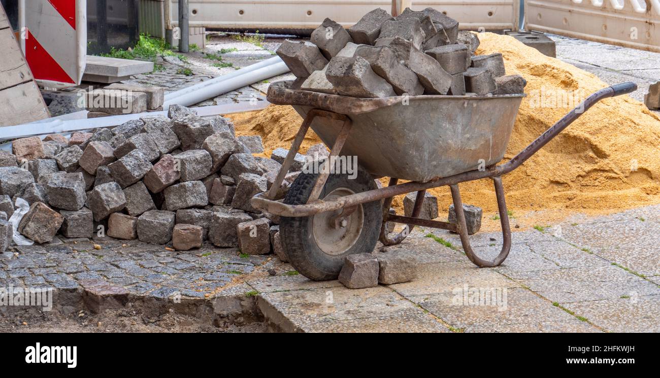 wheelbarrow with bricks on a construction site Stock Photo - Alamy