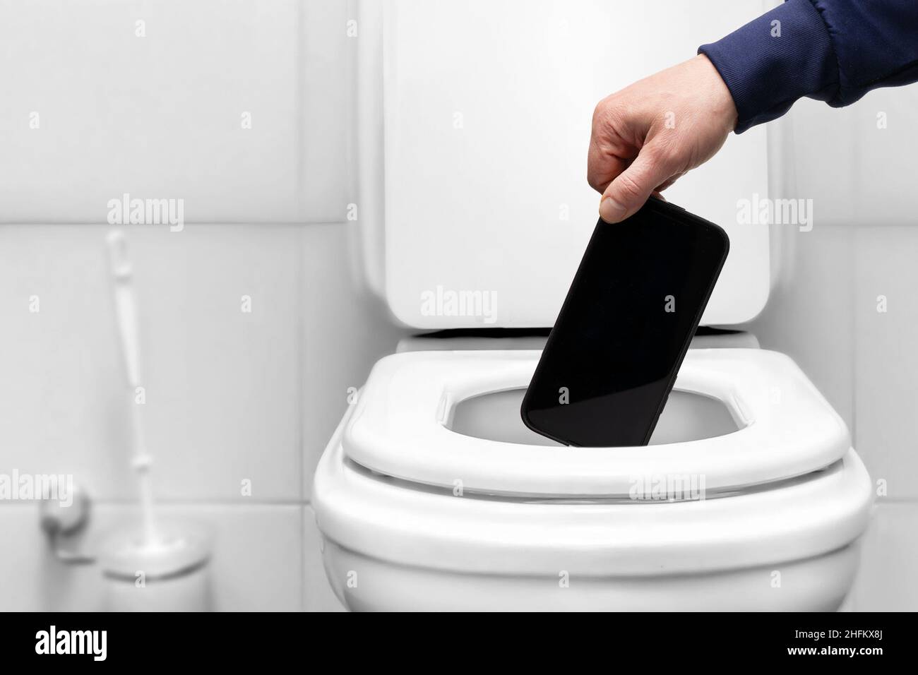 refusal of the phone. a man's hand throws the phone into the toilet ...