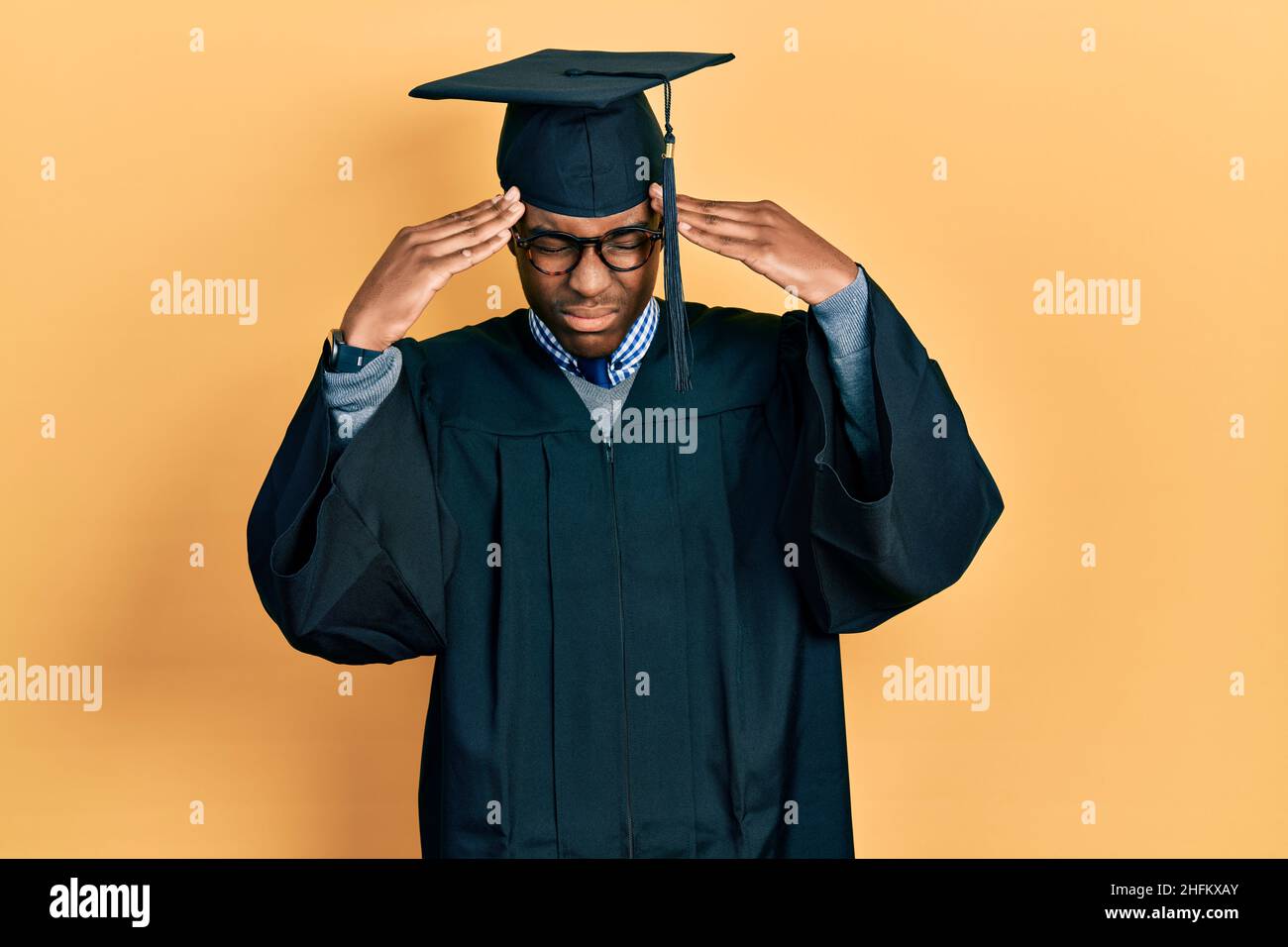 Young african american man wearing graduation cap and ceremony robe ...