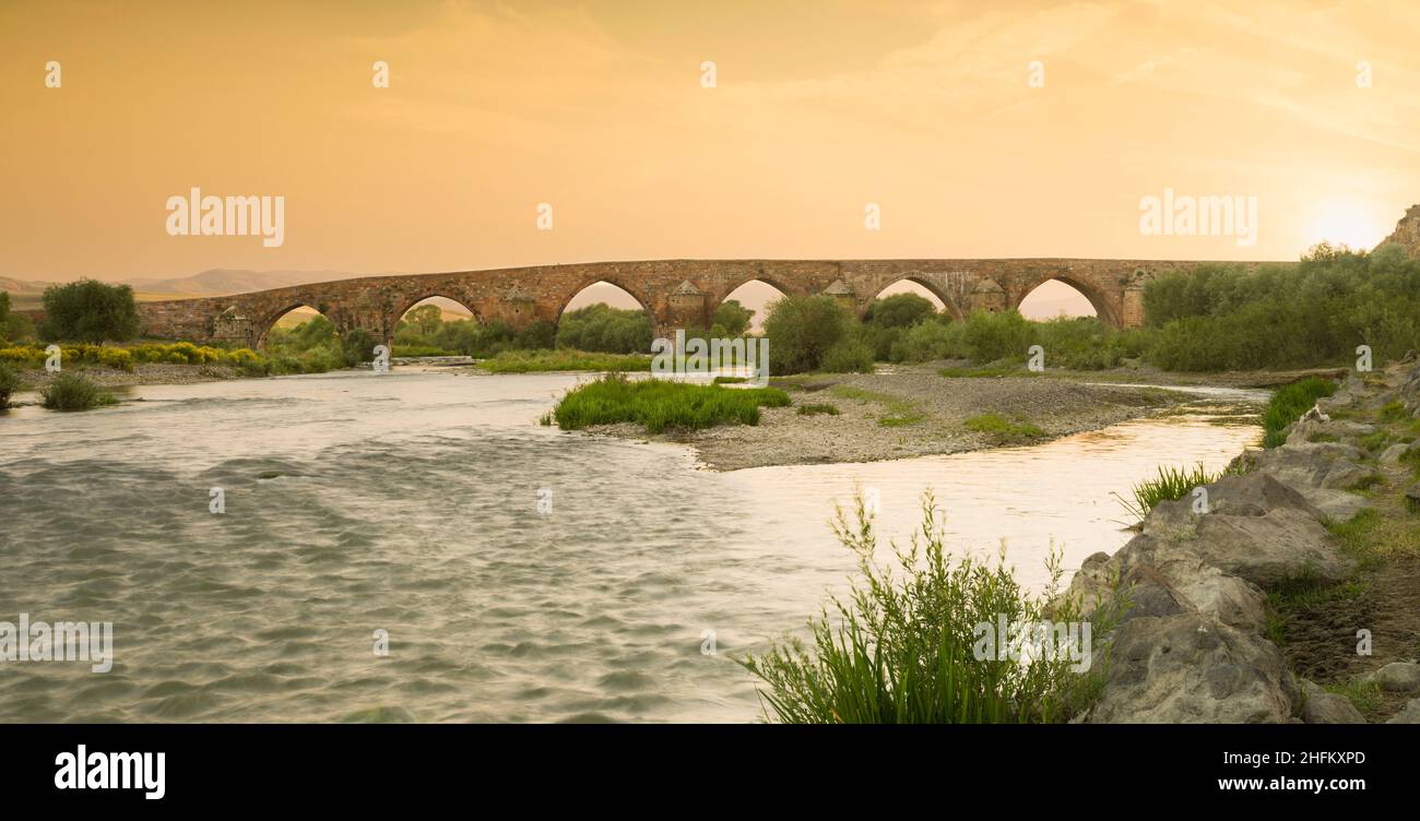 Cobandede bridge at sunset. The historical bridge over the Aras River ...