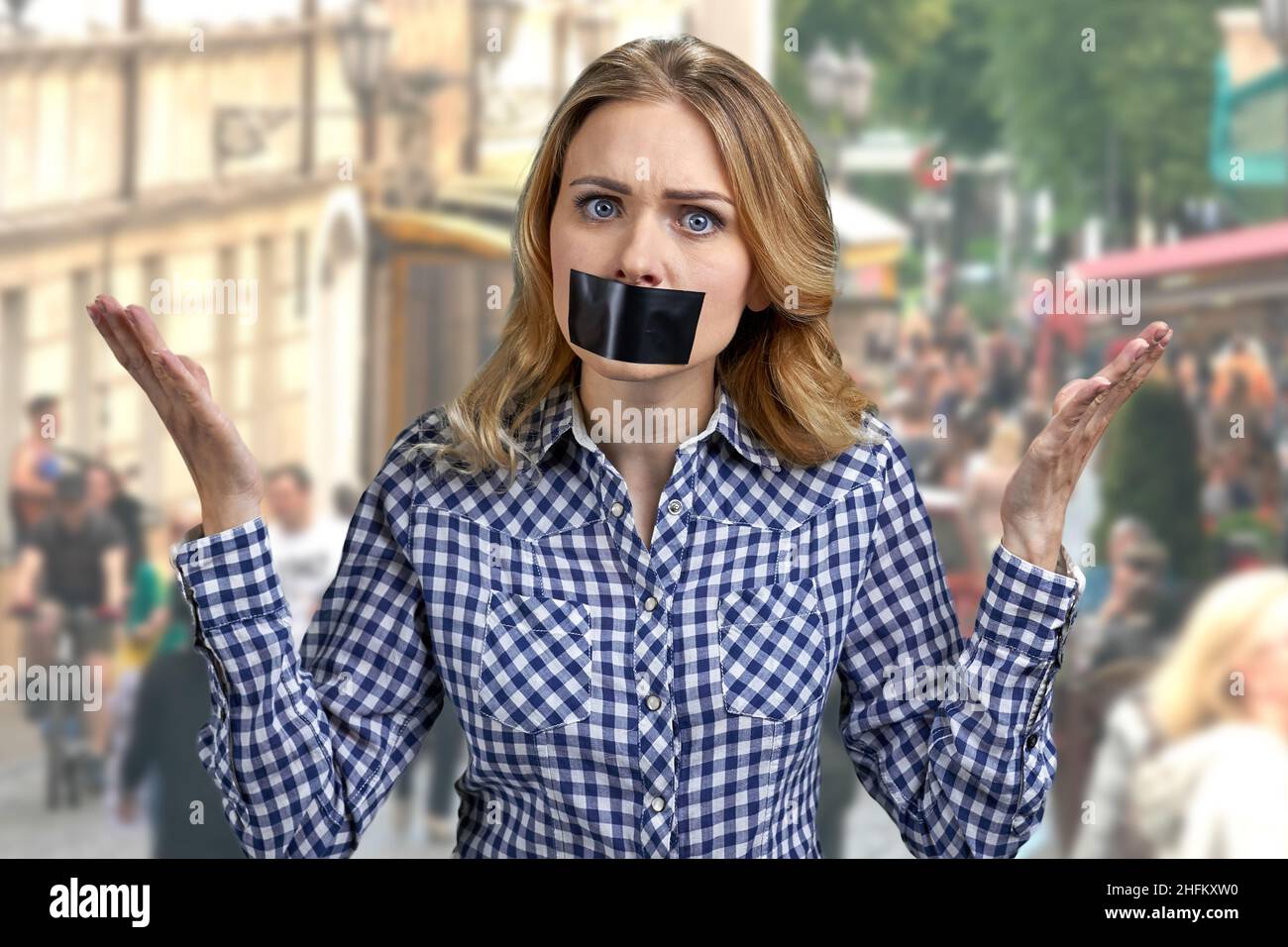 Female protestor with black tape over her mouth demonstrating protest ...
