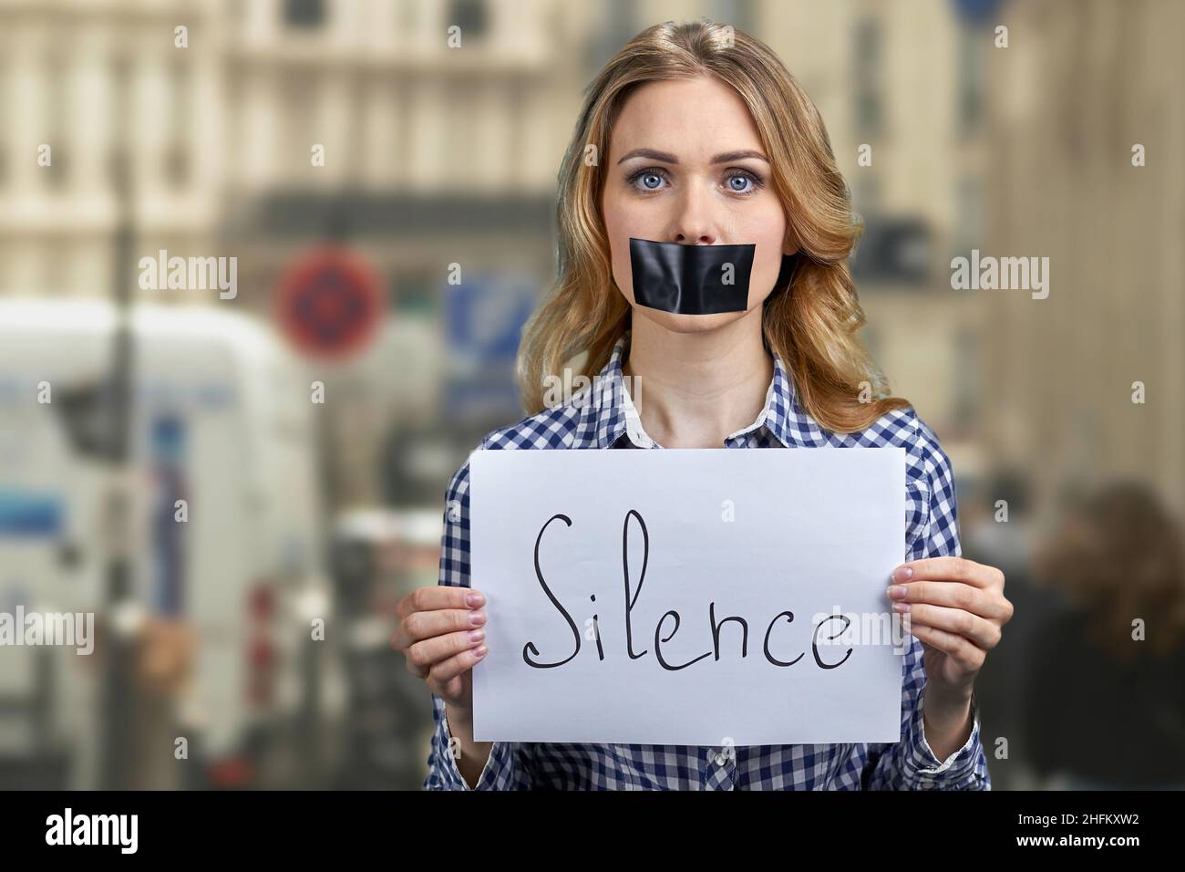 Young woman activist holding banner with handwritten inscription ...