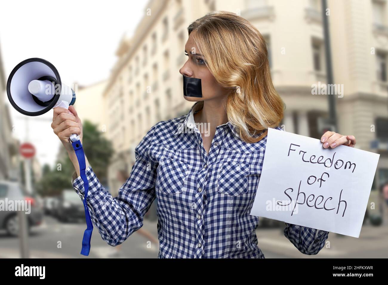 Young speechless woman with adhesive tape on mouth unable to speak in ...