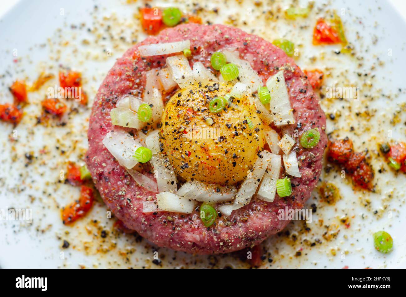 Beef steak tartare with raw egg yolk and onion with tomato, appetizer ...