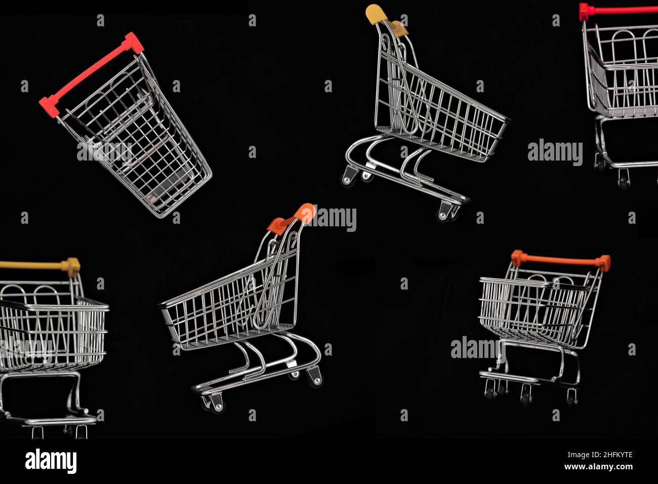 Shopping carts of different colors isolated on black background Stock ...