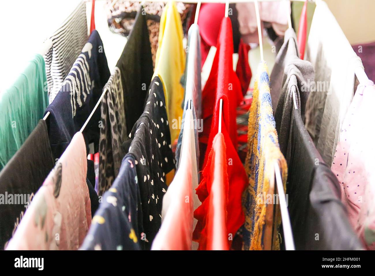 Colorful different dress and laundry hanging on a drying rack Stock ...