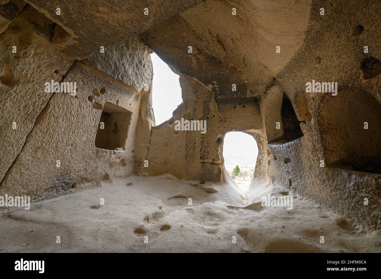 Cave church in Goreme, Cappadocia, Turkey. Cave town and houses at rock ...