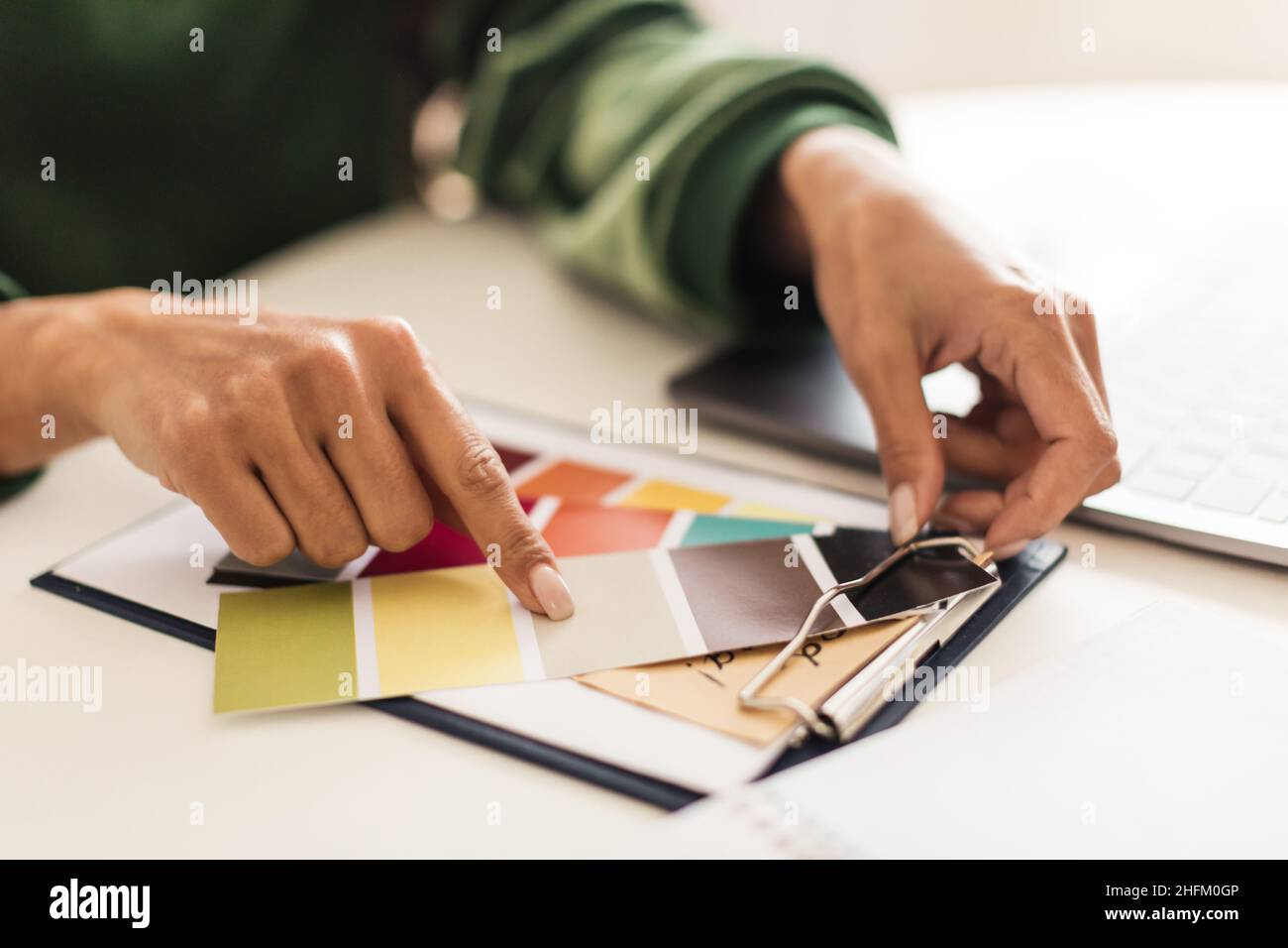 Closeup Of Female Hands Holding And Choosing Color Palettes Indoor ...