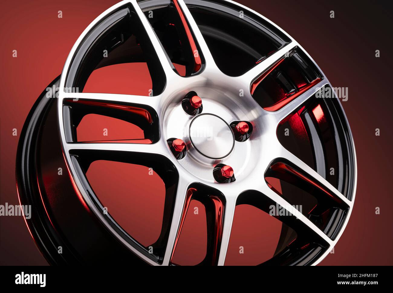 beautiful red alloy wheels close-up, sporty style wheel nuts in red on ...