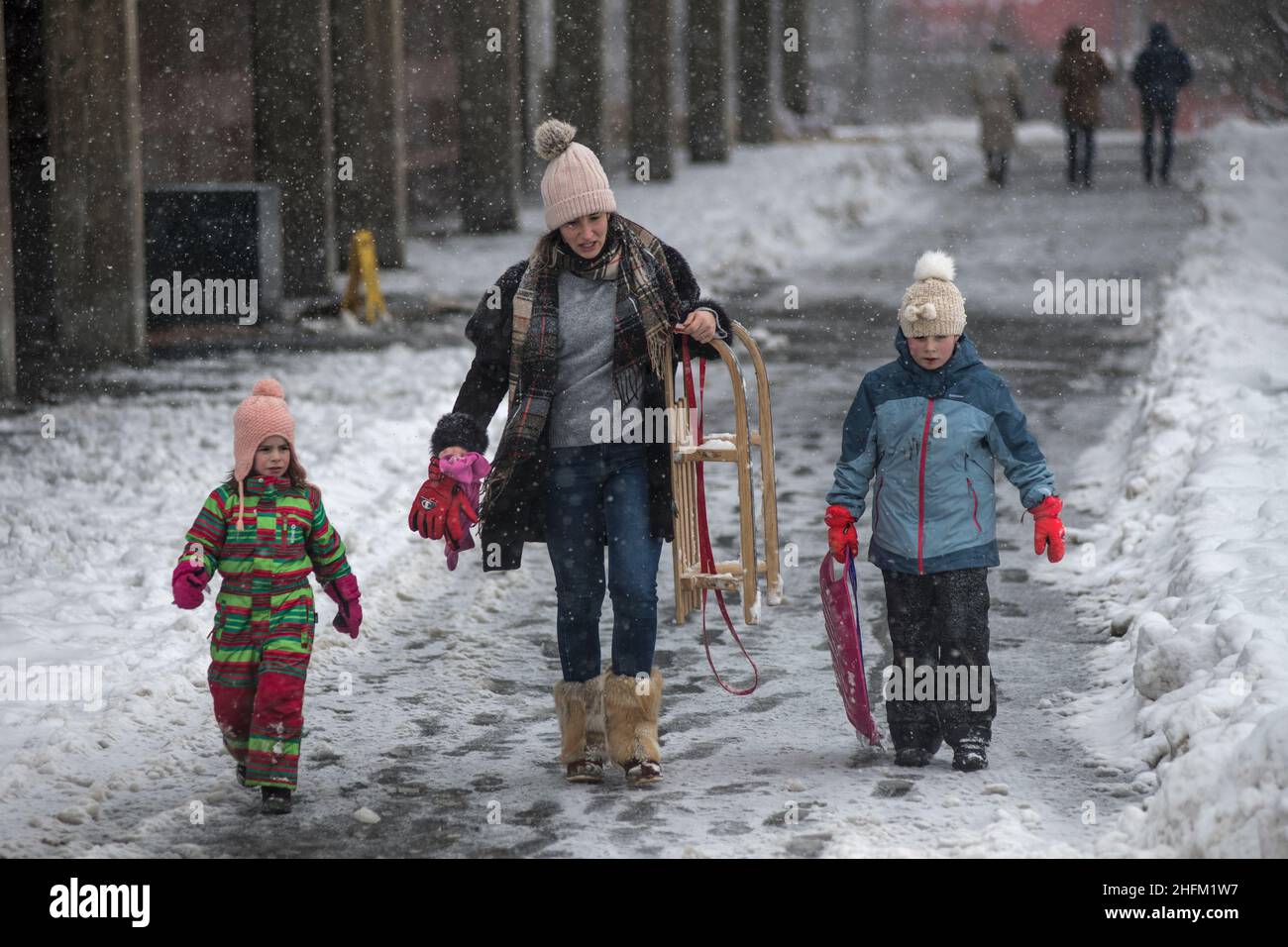 Winter in Serbia: mother with her son and daughter walking in the snow ...