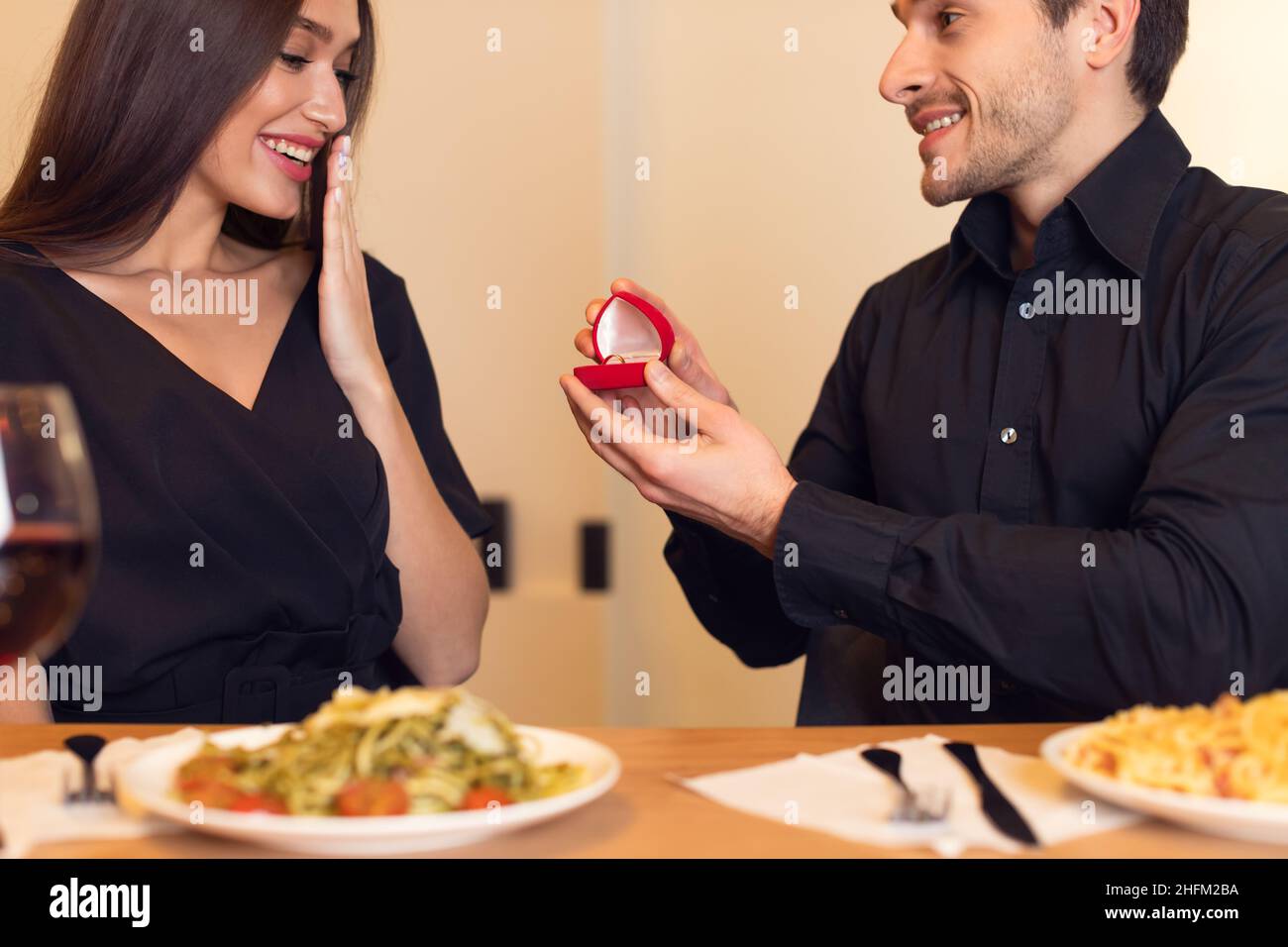 Smiling man making proposal with ring to his fiance Stock Photo - Alamy