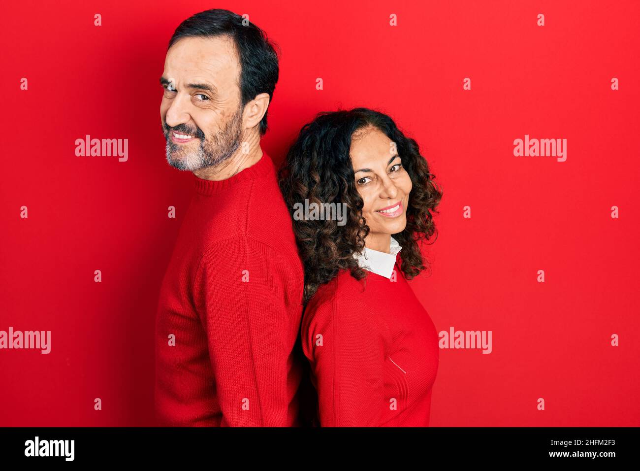 Middle age couple of hispanic woman and man hugging and standing ...