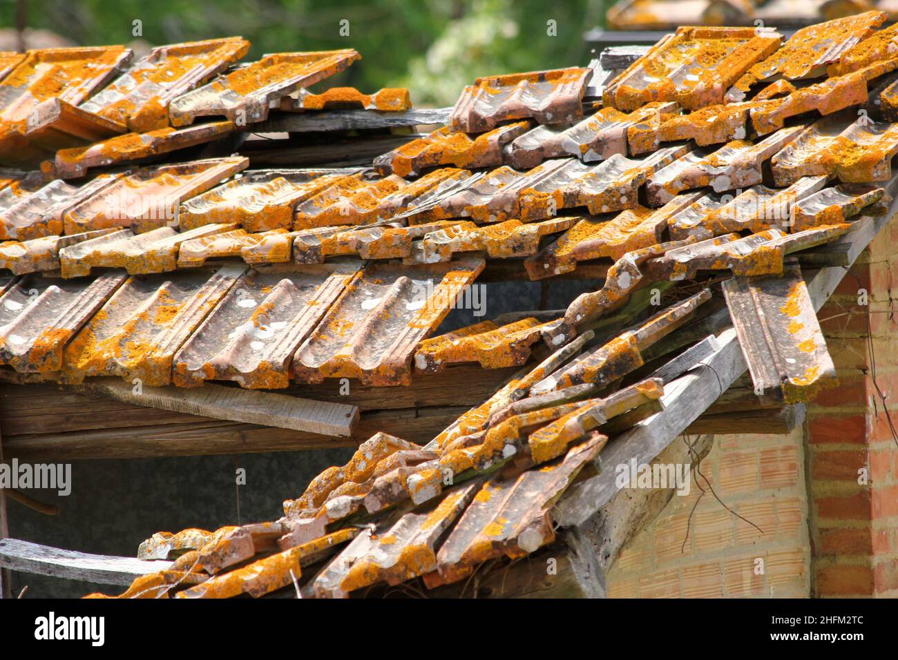 The detail of the old crooked and destroyed roof on the old village ...