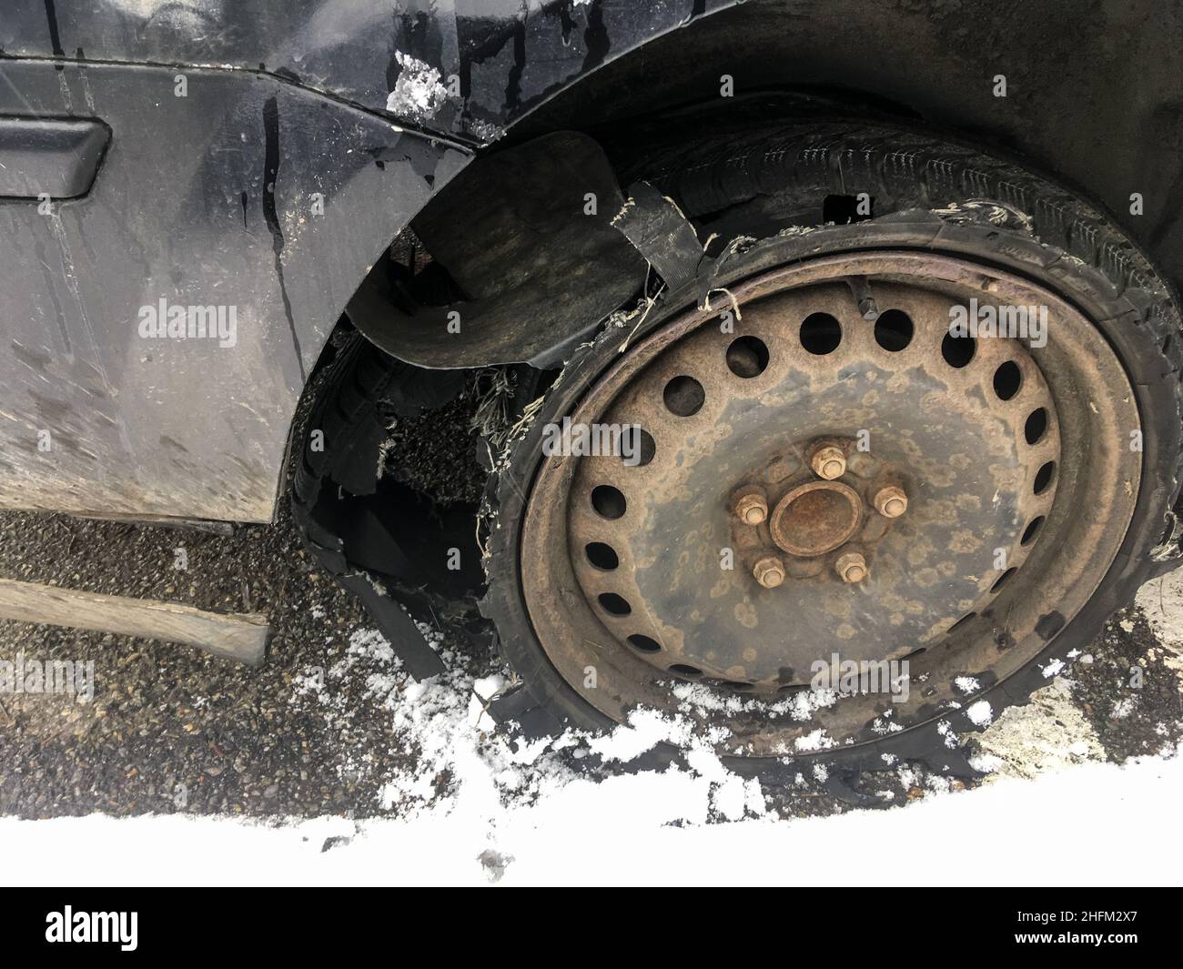 The detail of rusty wheel with flat, destroyed tire on the abandoned ...