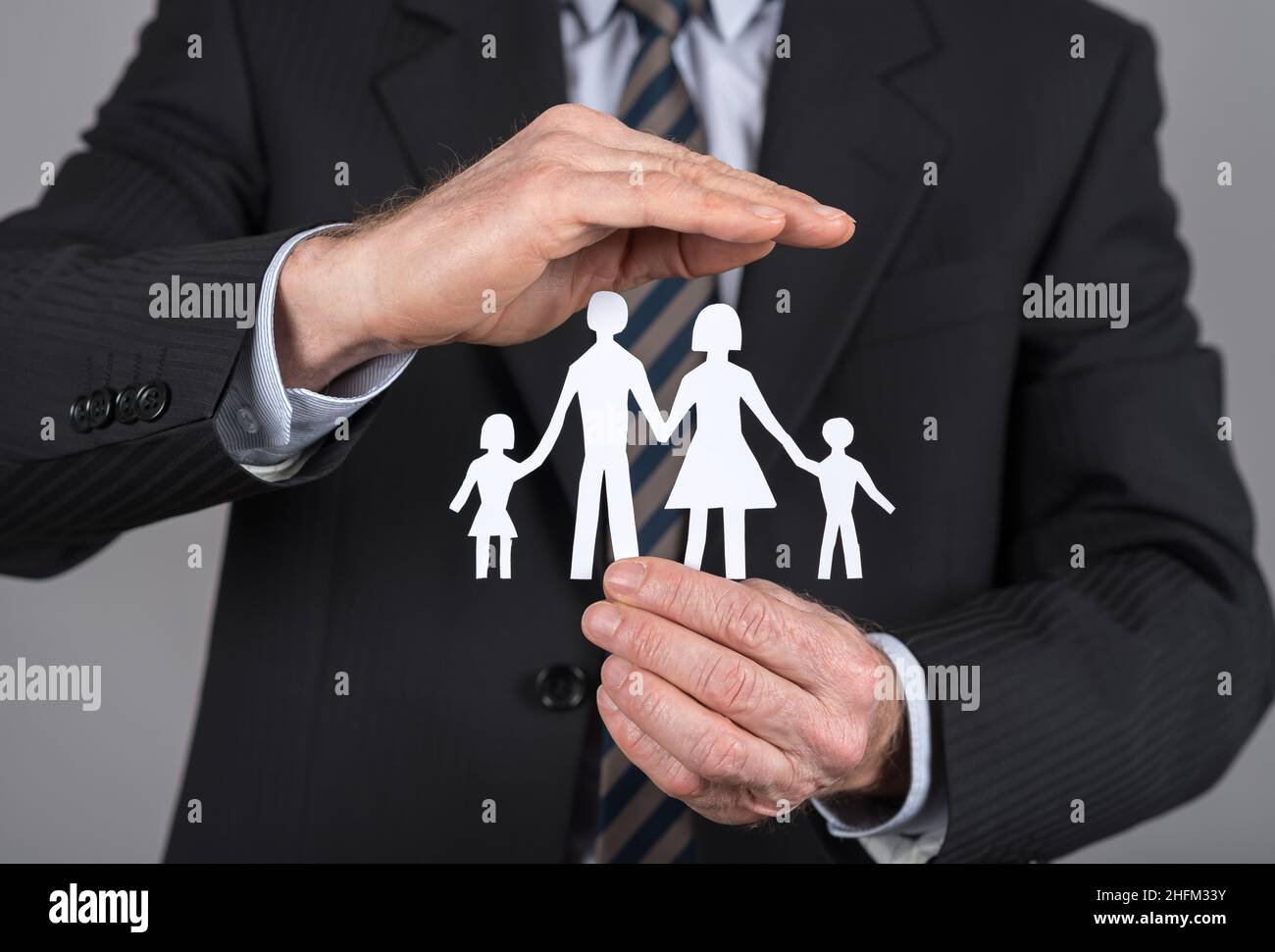 Insurance concept, man protecting a family with his hand Stock Photo ...