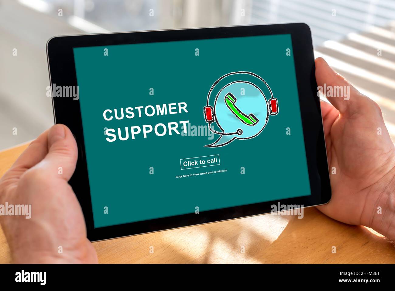 Male hands holding a tablet with customer support concept Stock Photo ...