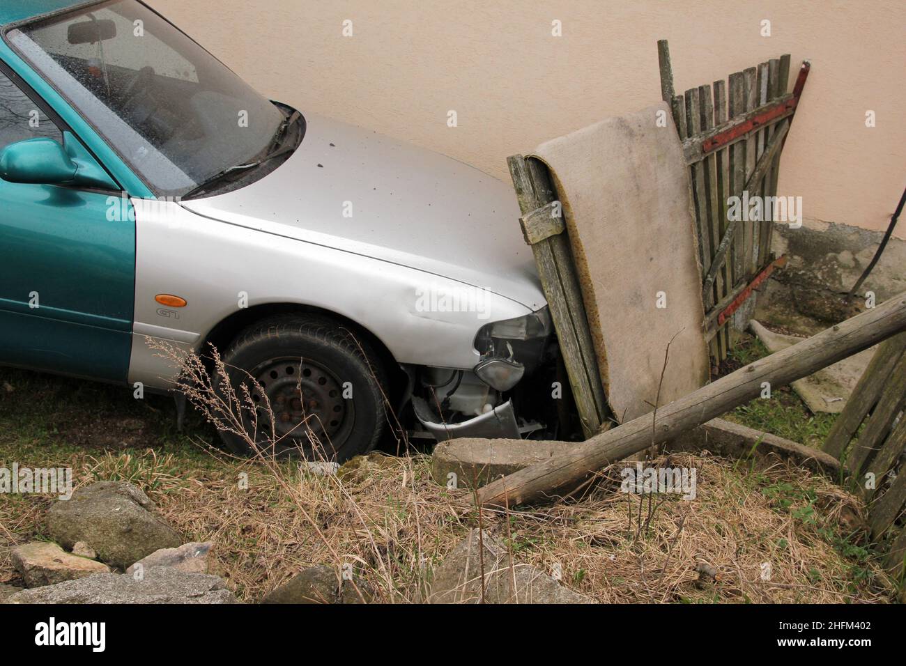 The detail of an old car in desolate state. It is rusty and shabby with ...