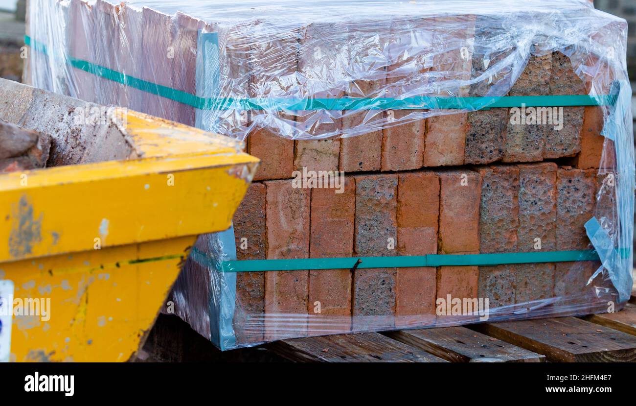 A delivery of building bricks on a wooden pallet. They have been placed ...