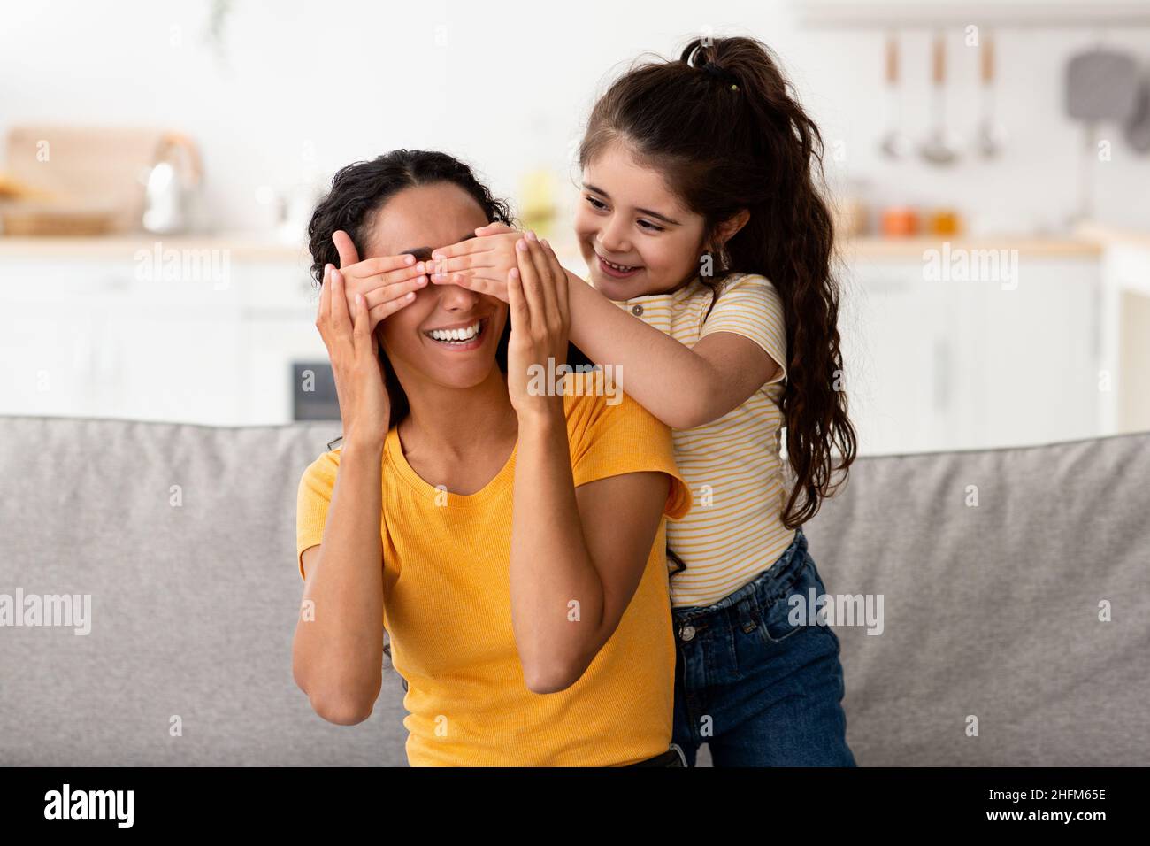 Fun With Mom. Cute Little Girl Playing Guess Who Game With Mother Stock ...