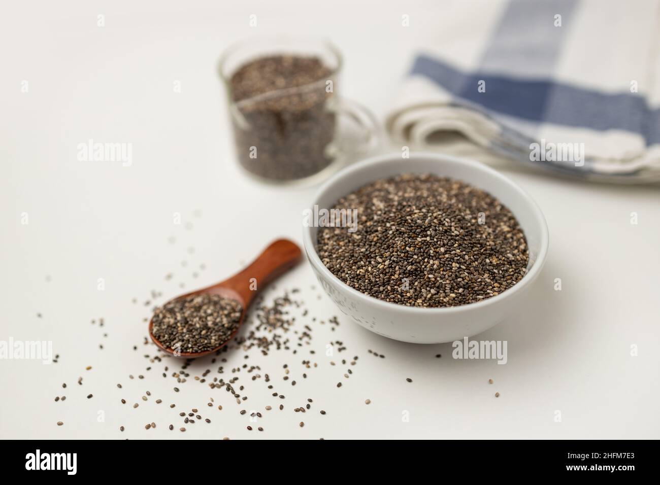Chia seeds in wooden spoon and cup from top view with space on white ...