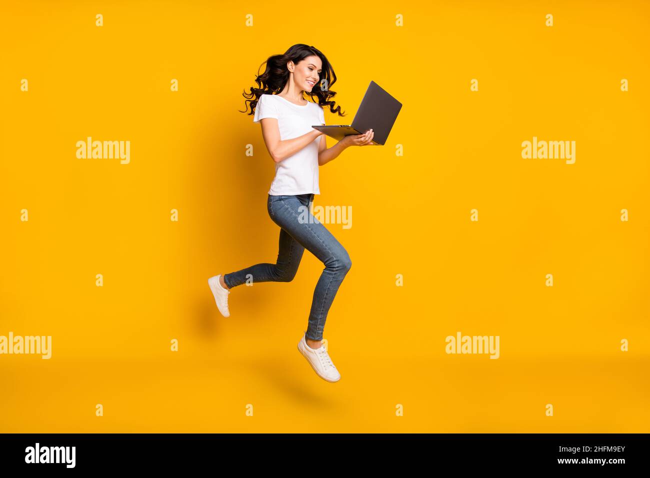 Photo of cute pretty young lady dressed white t-shirt jumping high ...