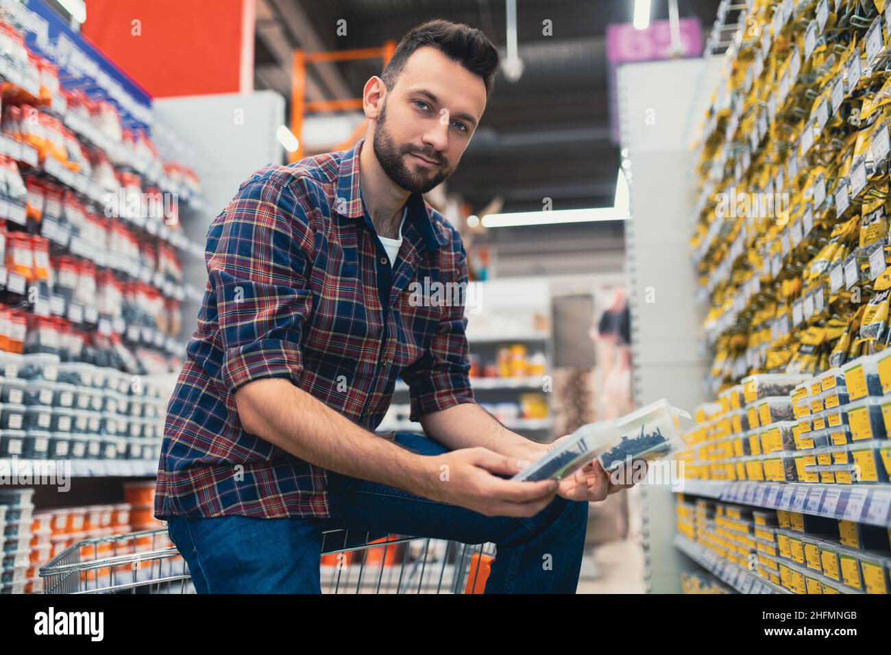hardware store customer chooses wood screws Stock Photo - Alamy
